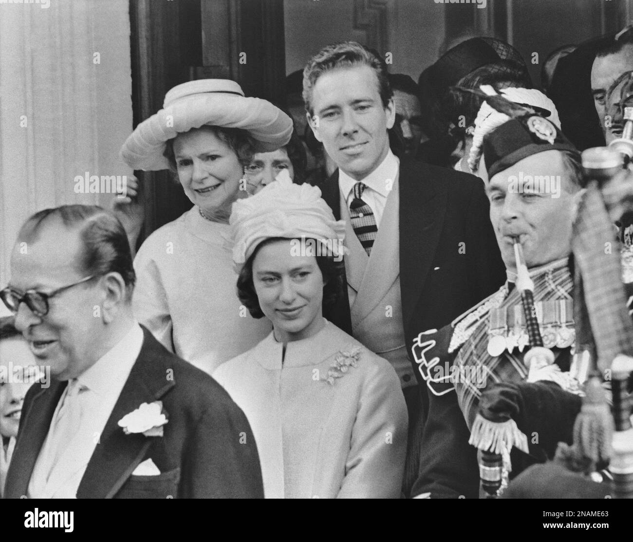 Princess Margaret and her husband Lord Snowdon walk past a piper in ...