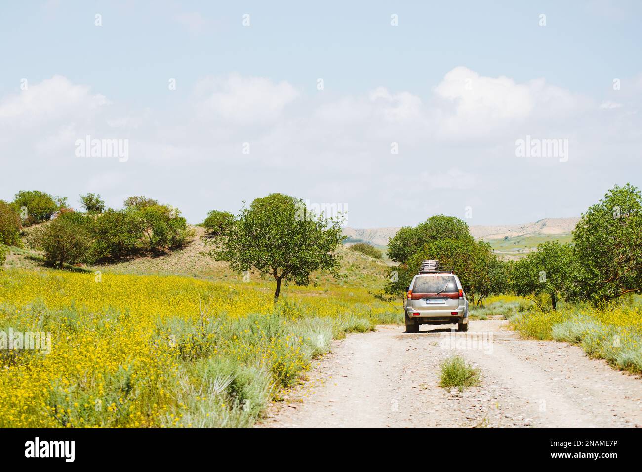 Back view 4WD vehicle drive on gravel road off-road in Vashlovani ...