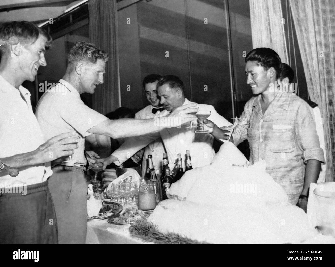 Colonel John Hunt, leader of the British Everest Expedition, clinks ...