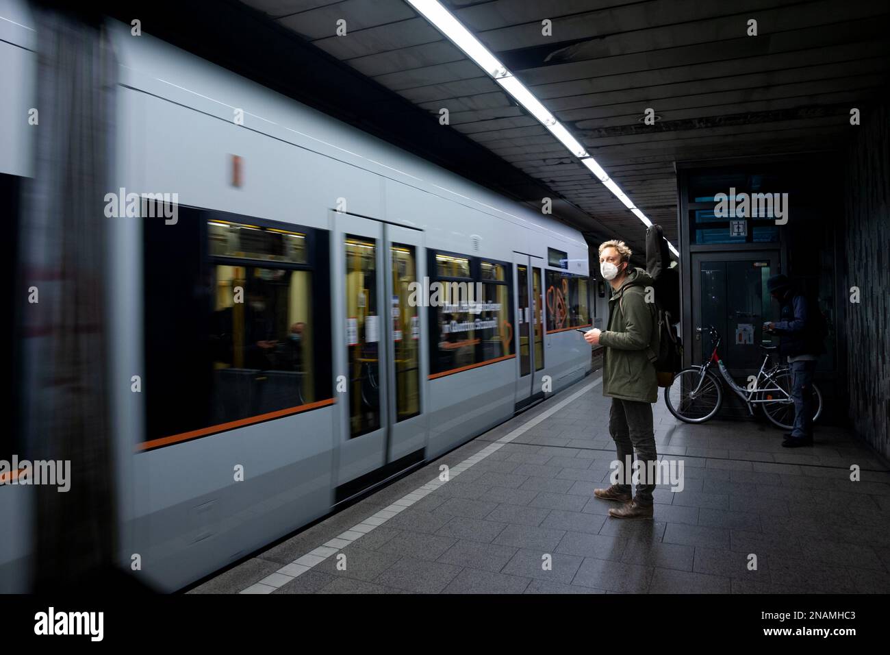Picture of a man waiting for a train on the platforms of Cologne Kolnu ...