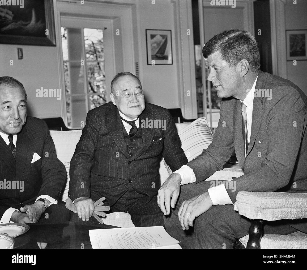 President John F. Kennedy is an attentive listener as he visits with ...