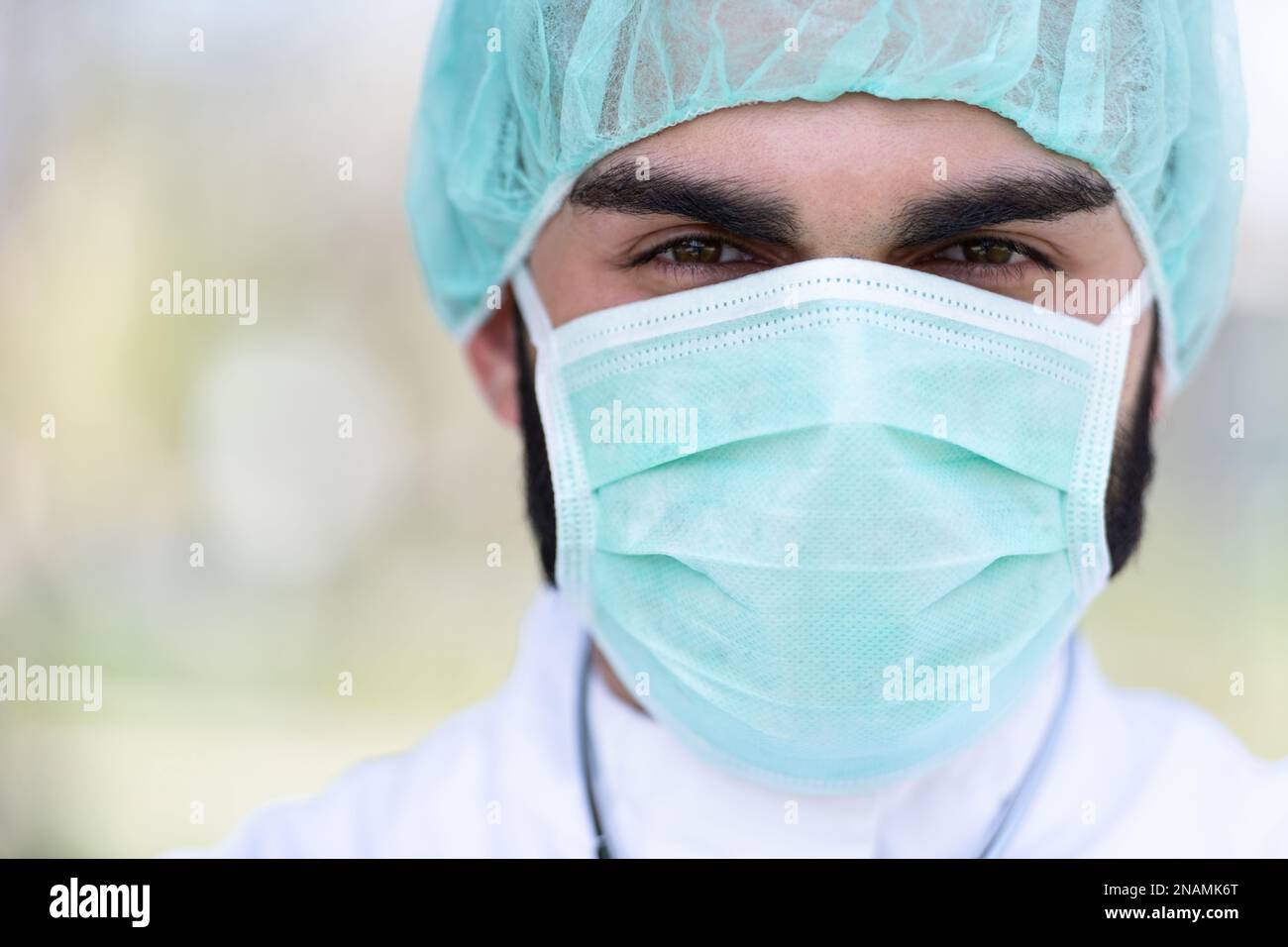 The portrait of a doctor with a facemask covering his face Stock Photo ...