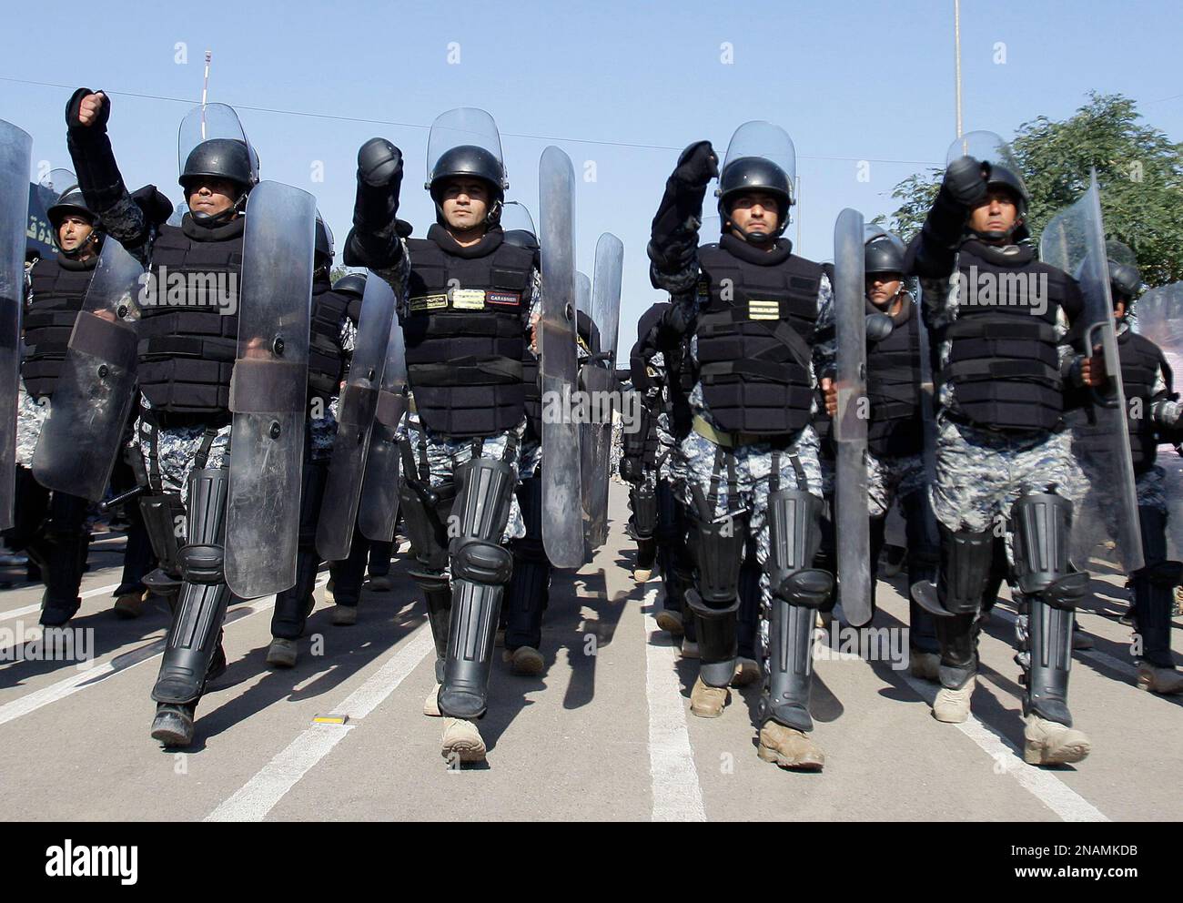 In this Tuesday, Nov. 22, 2011 photo, Iraq riot police march in Baghdad ...