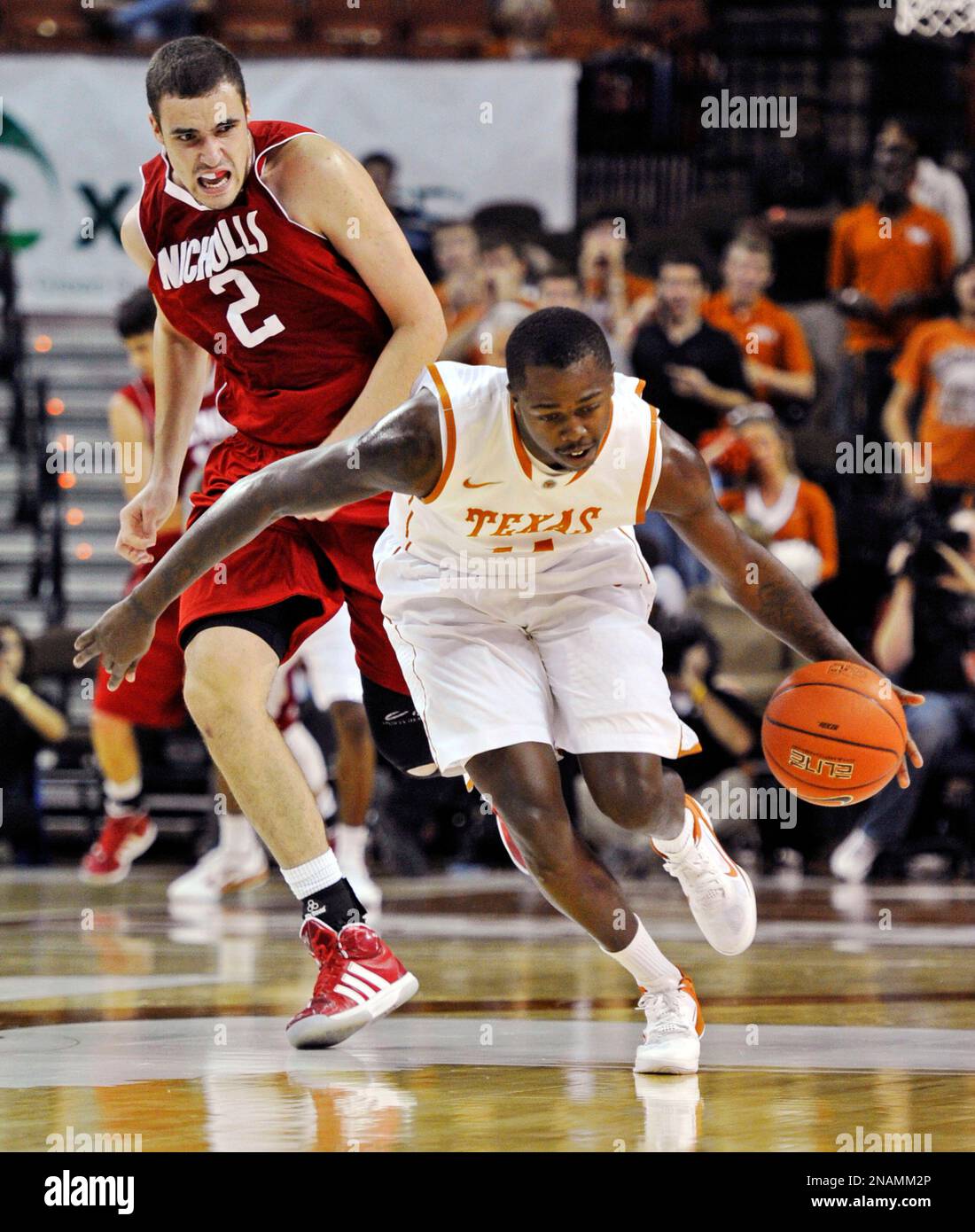 Texas guard J'Covan Brown, right, comes away with a loose ball against ...
