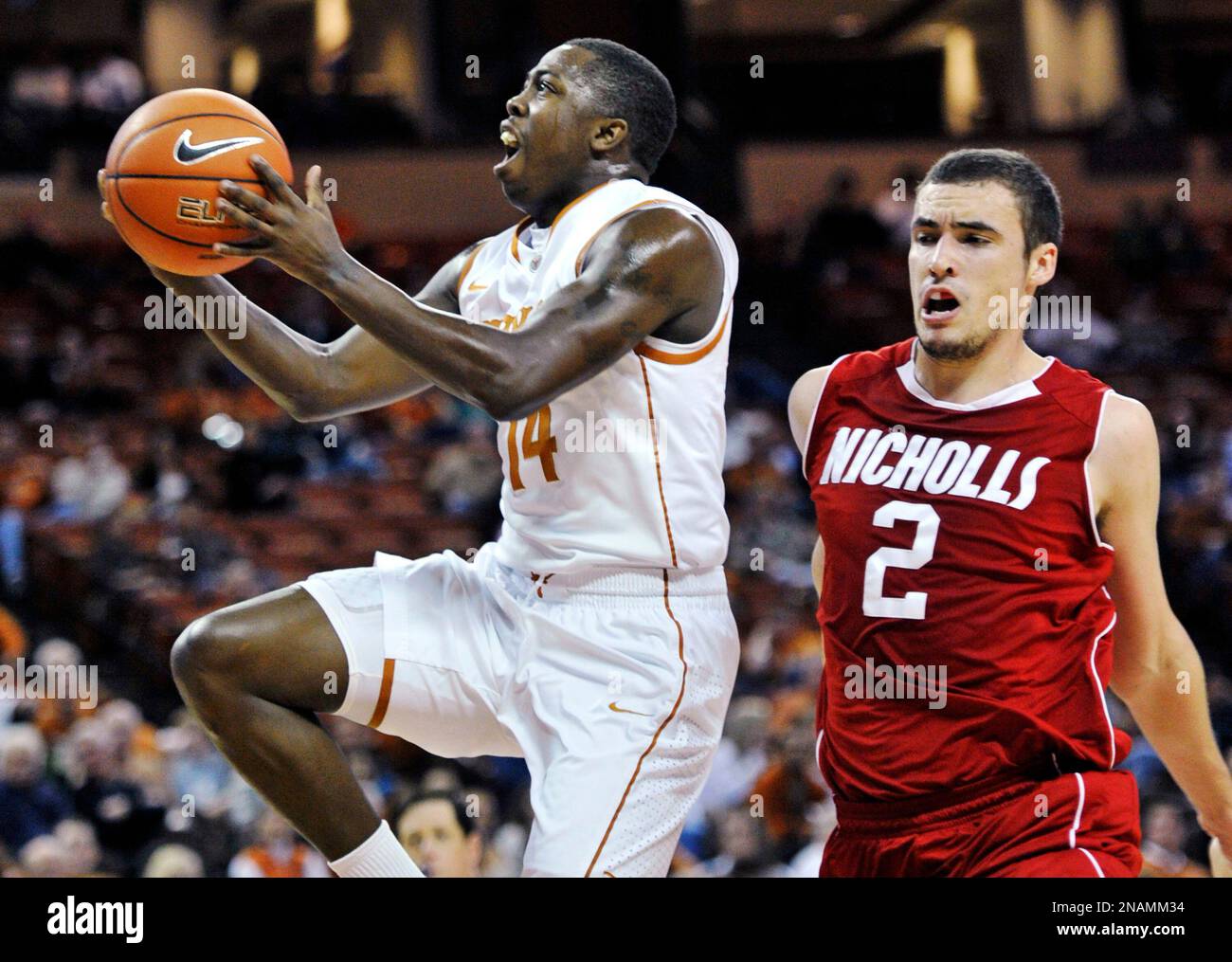 Texas guard J'Covan Brown, left, goes to the basket against Nicholls ...