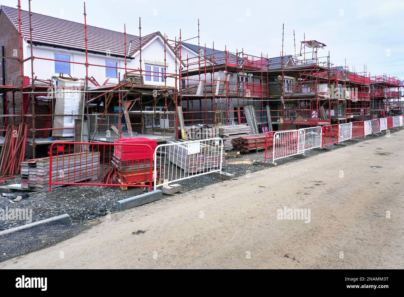 Modern houses under construction with scaffolding and access ...
