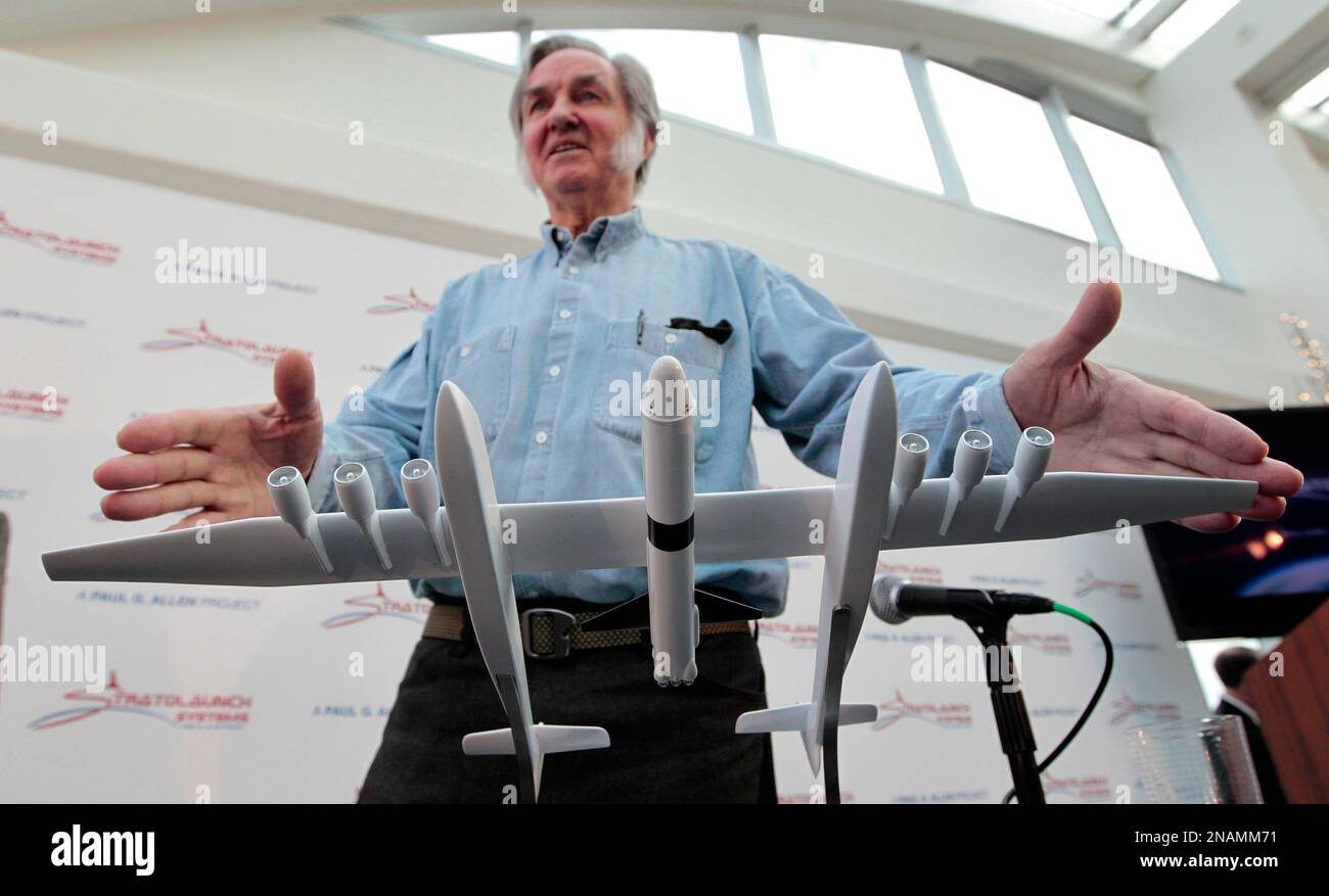 Aerospace pioneer Burt Rutan points to the model of the plane as he ...