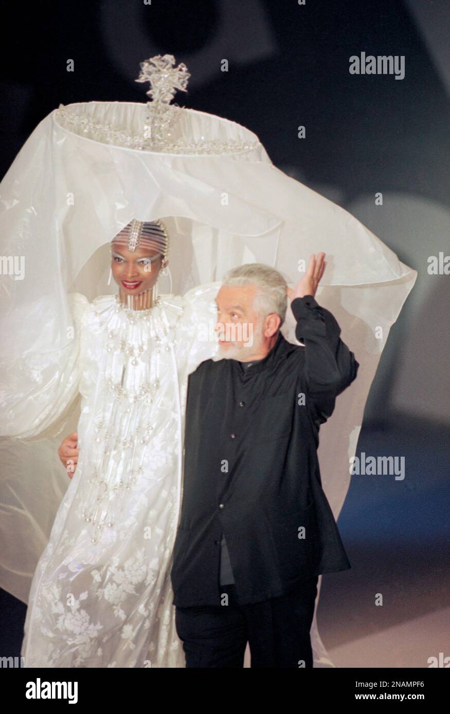 Spanish fashion designer Paco Rabanne poses with a model wearing a ...