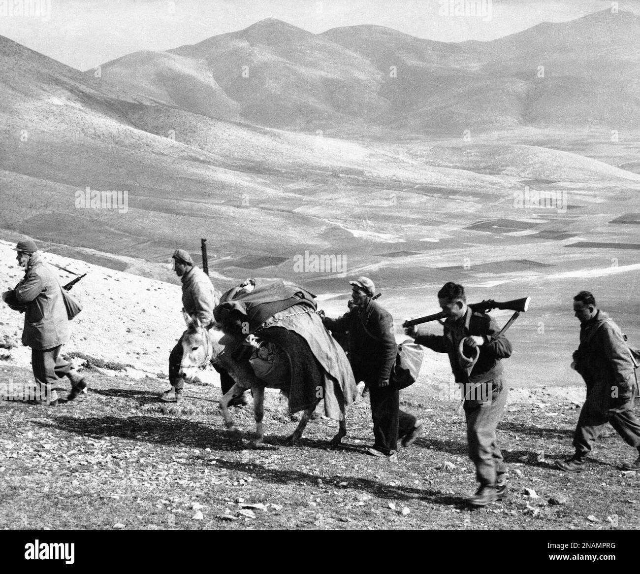 Greek army troops are seen advancing up a slope in the Grammos ...