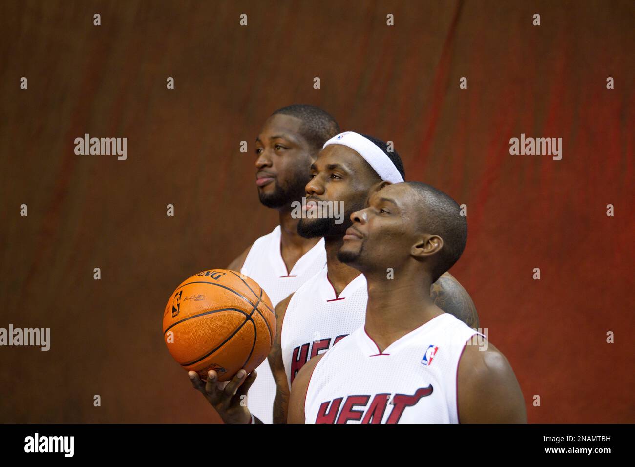Miami Heat players Dwyane Wade, back, LeBron James, and Chris Bosh pose ...