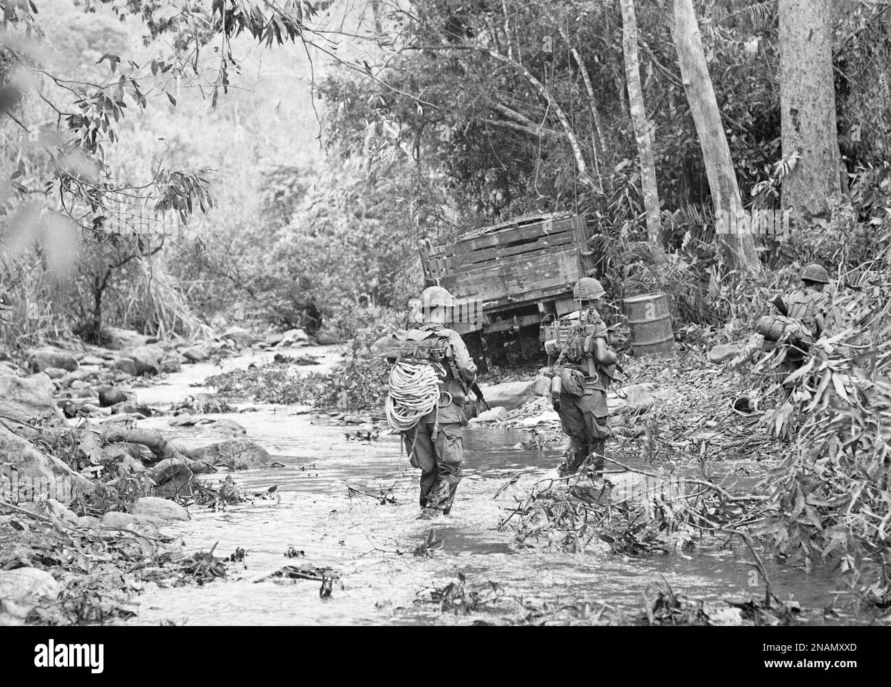 Soldiers walk in a shallow stream during Operation Delaware in the A ...
