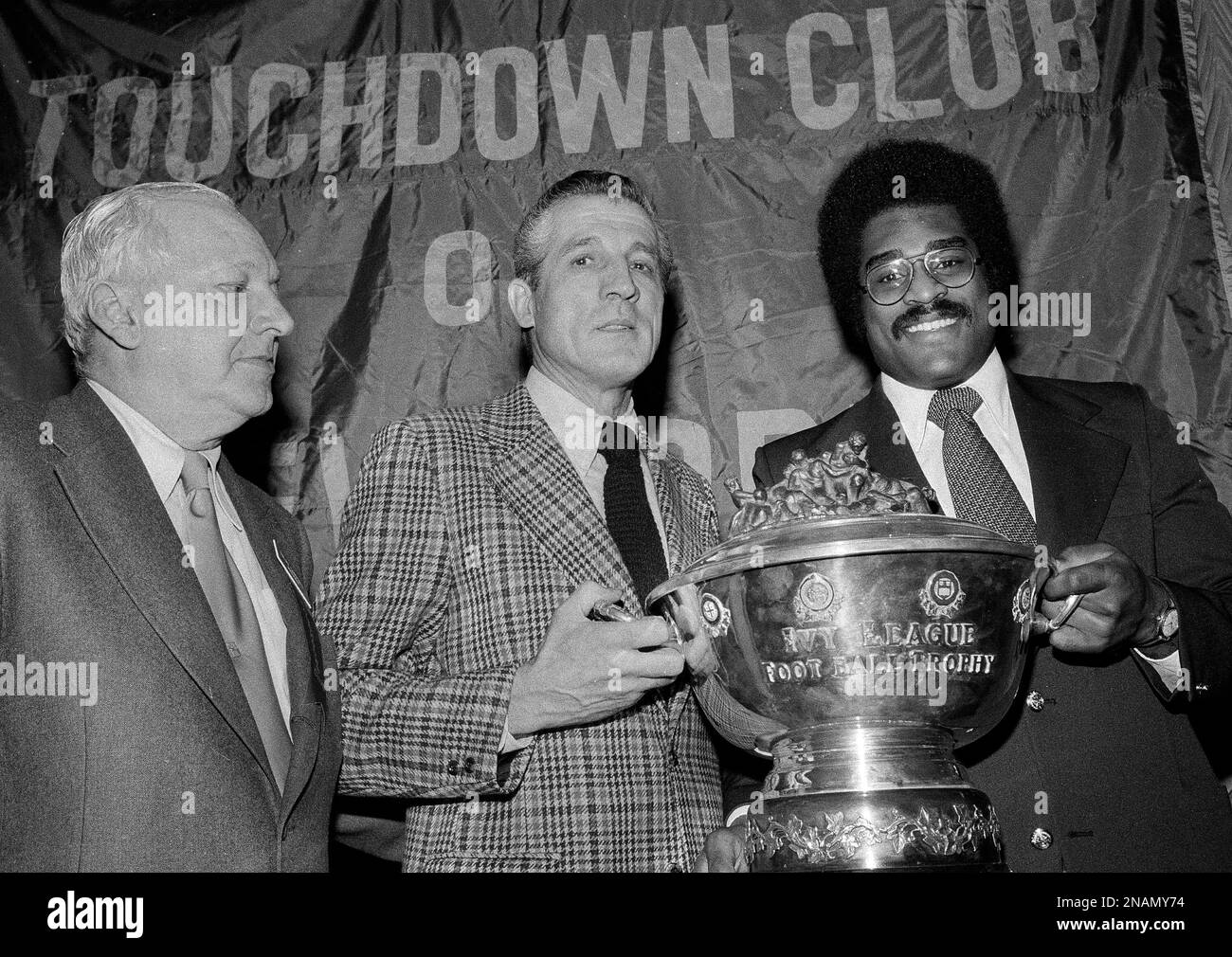 Coach Joe Restic of the Harvard football team, center, and team captain ...