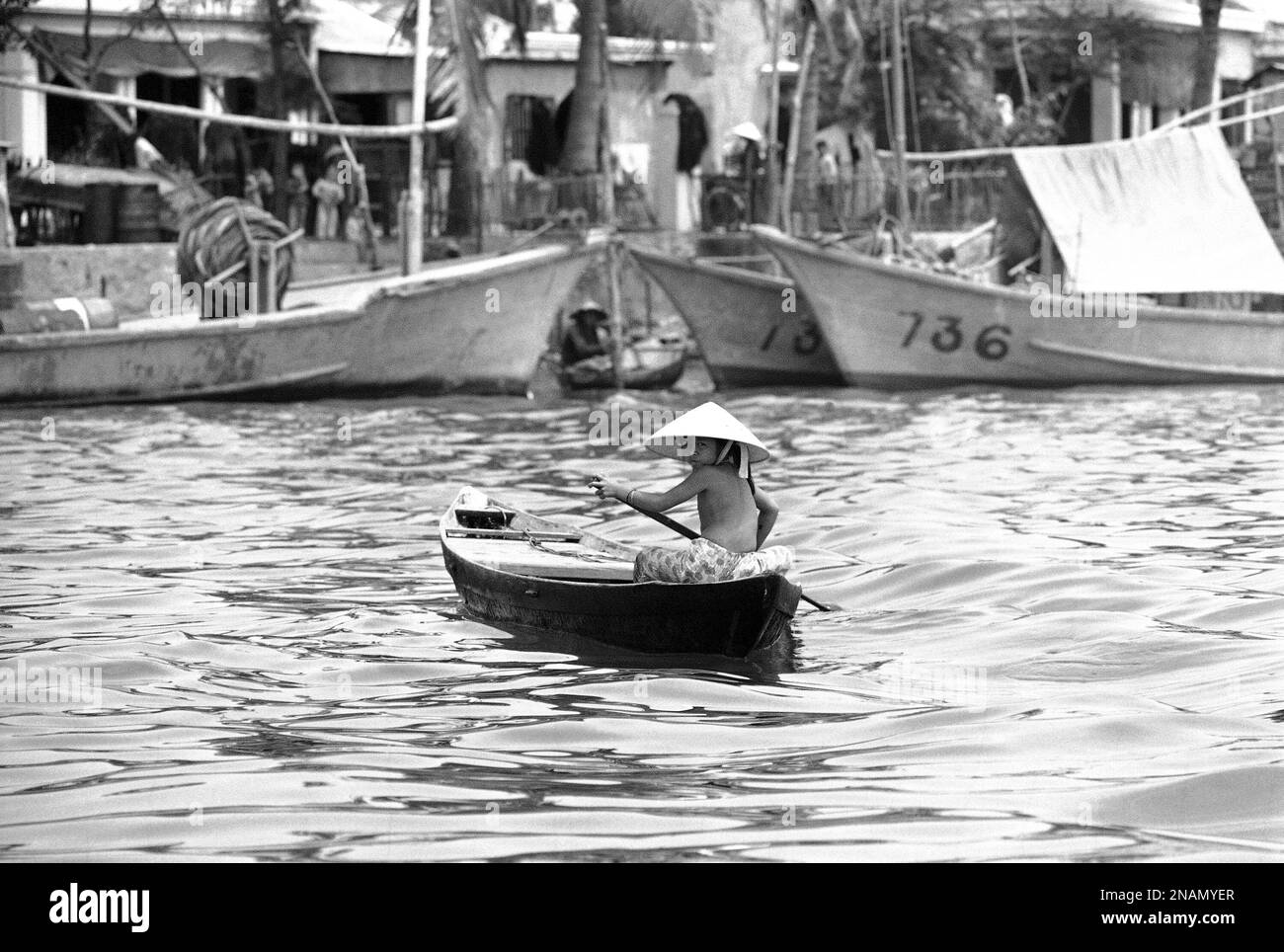 A rowboat is paddled in a river during the Vietnam War in April 1968 in ...