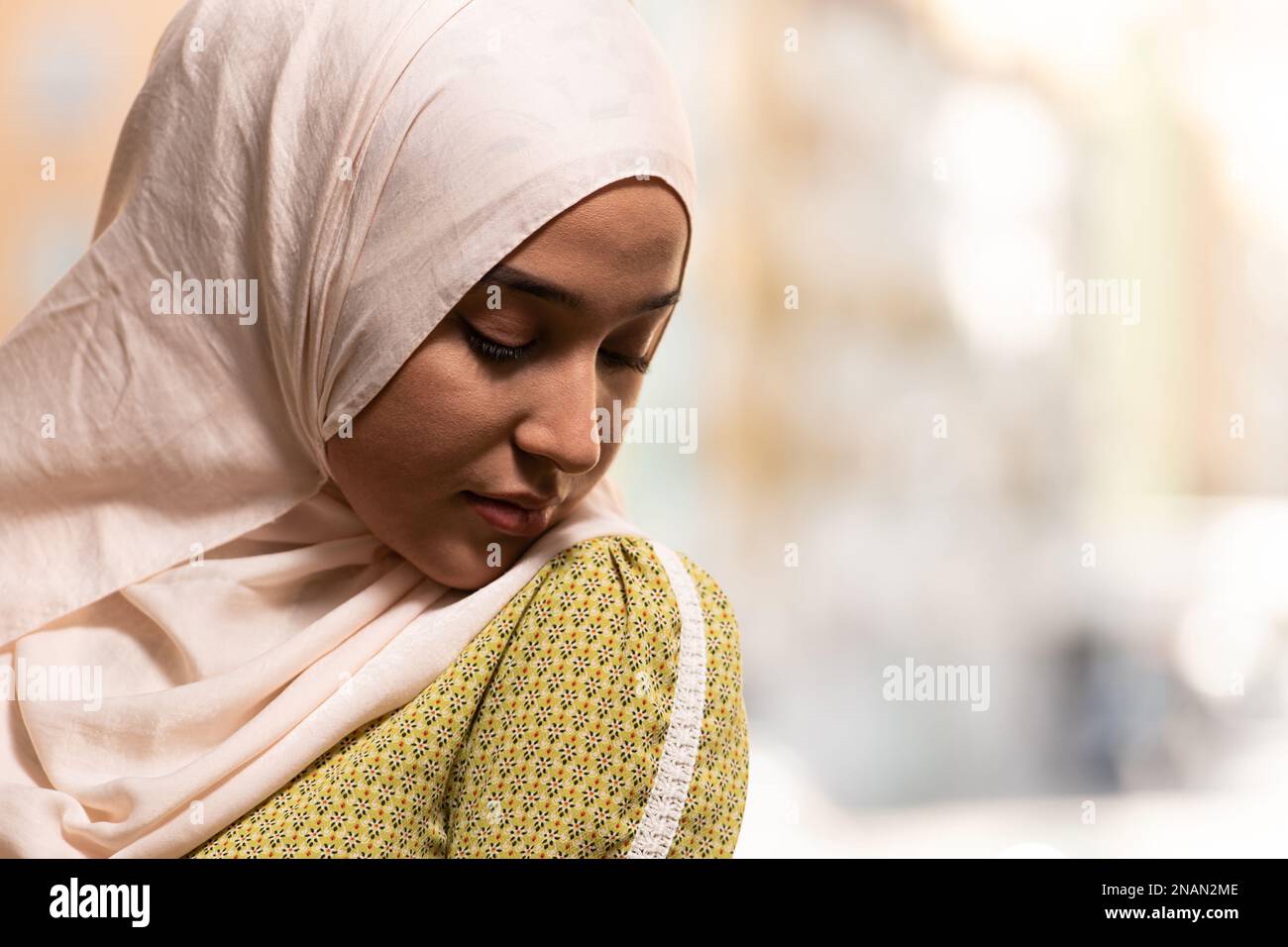 A profile portrait of a Muslim woman looking to the side while wearing ...