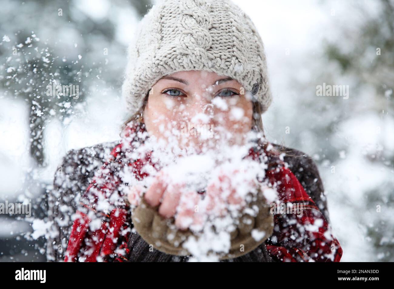 Woman blowing snow Stock Photo - Alamy