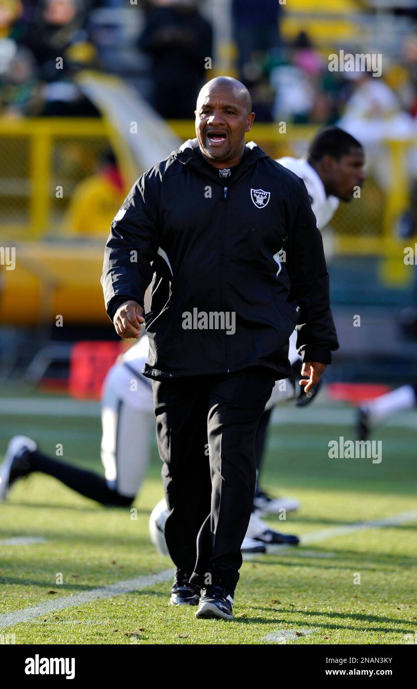 Oakland Raiders head coach Hue Jacksonwatches his team warm up before an NFL football game ...
