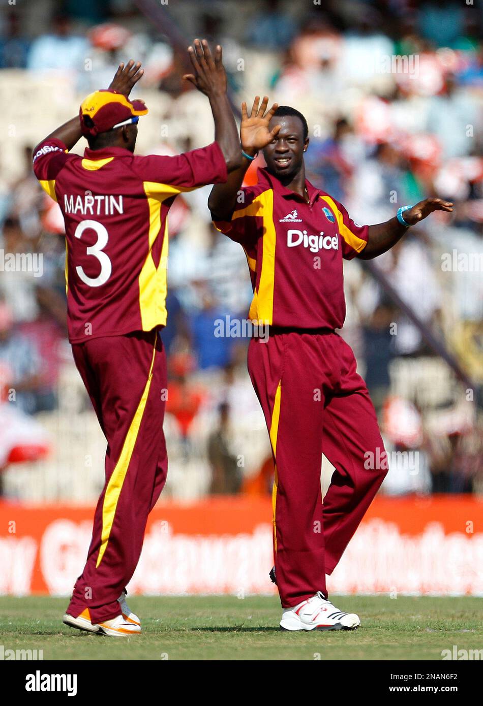 West Indies' bowler Kemar Roach, right, celebrates with teammate ...