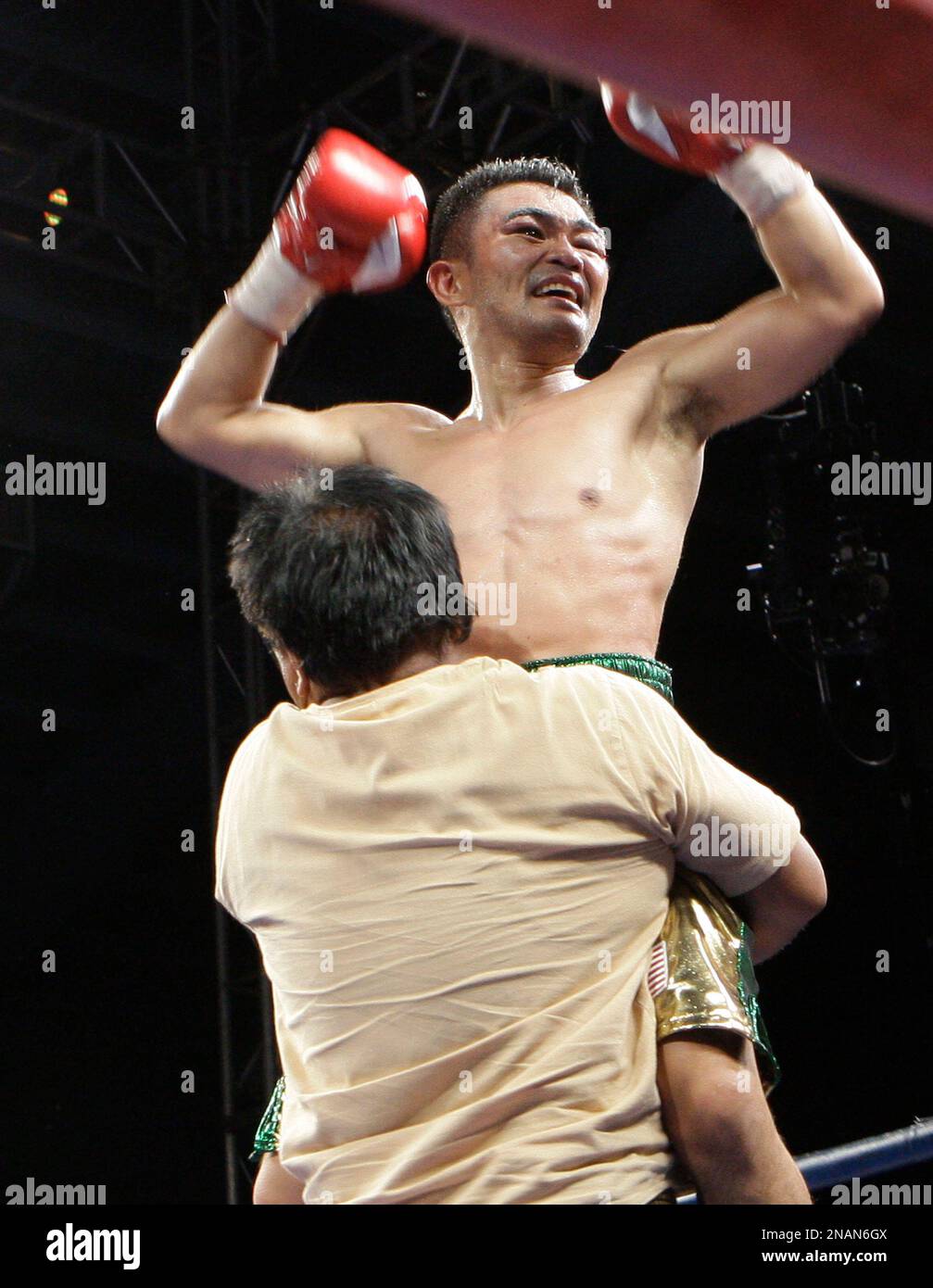 World Boxing Organization Flyweight champion Brian Viloria is lifted by ...