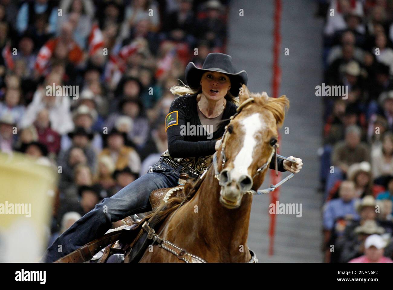 Lindsay Sears, of Canada, competes in the barrel racing competion ...