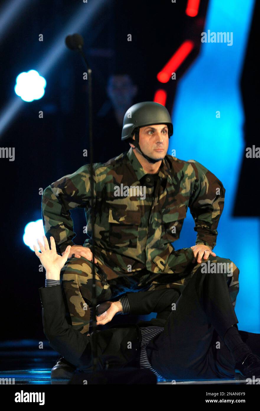 U.S. soldier Daniel Aldema is seen onstage with a representative of ...