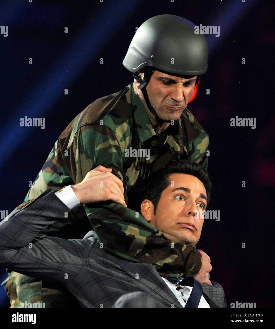 U.S. soldier Daniel Aldema, background, and host Zachary Levi are seen ...
