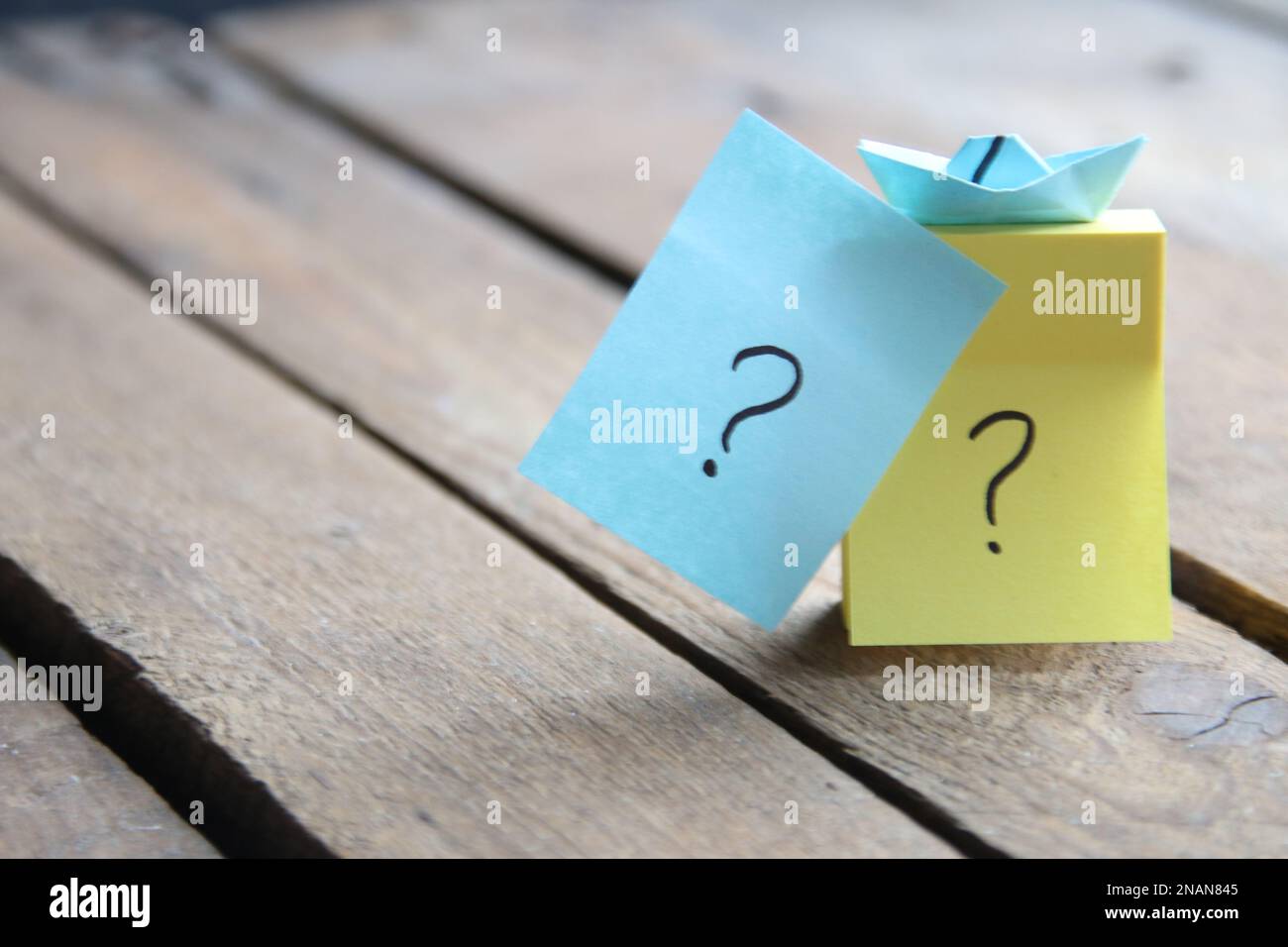 Large Question marks on cards on a wooden background Stock Photo - Alamy
