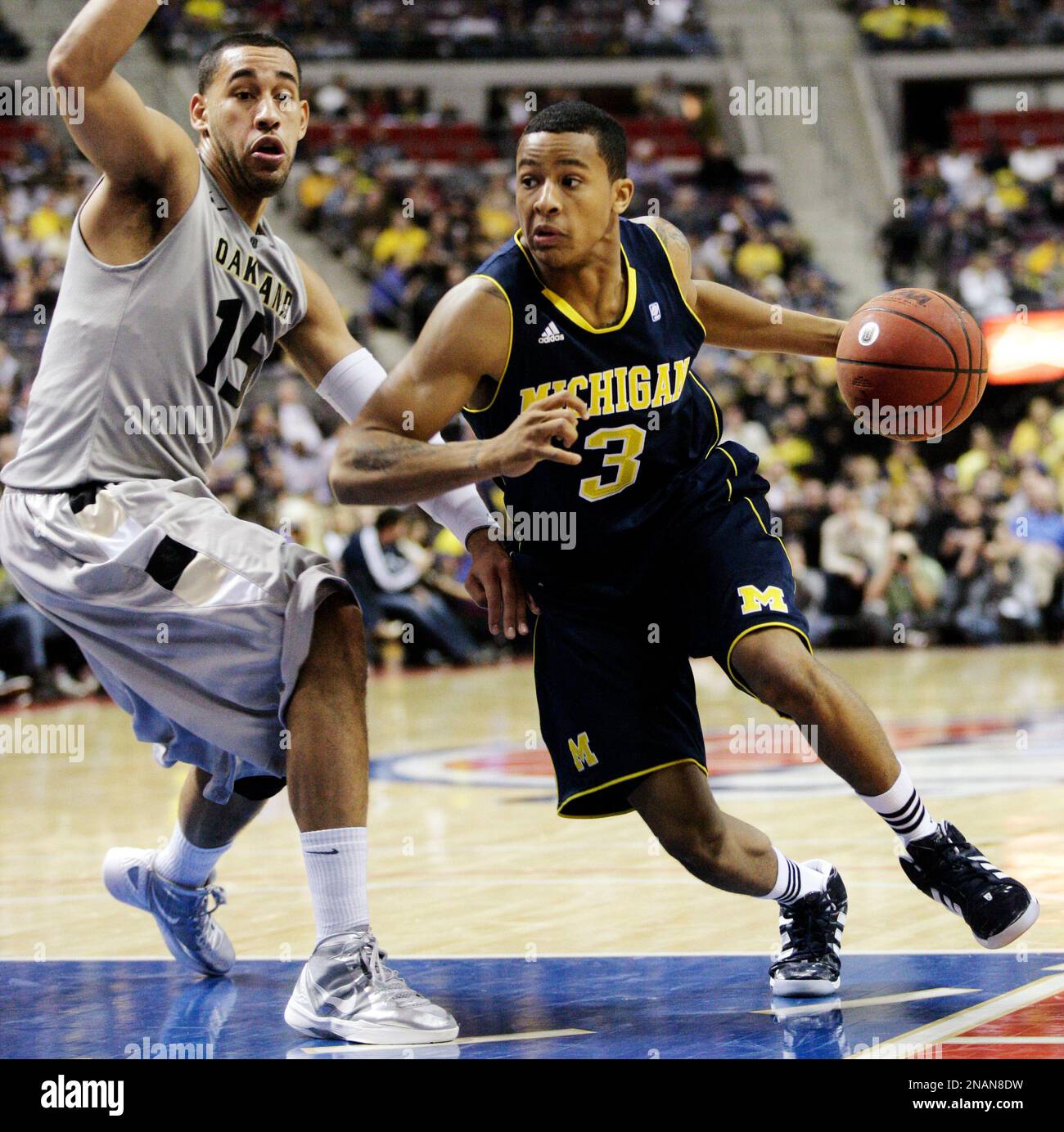 Michigan's Trey Burke (3) drives on Oakland's Drew Valentine (15) in ...
