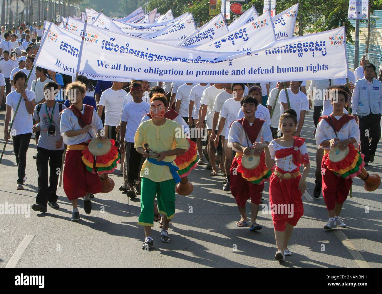 Cambodians perform their traditional drum dance as they lead a march to ...