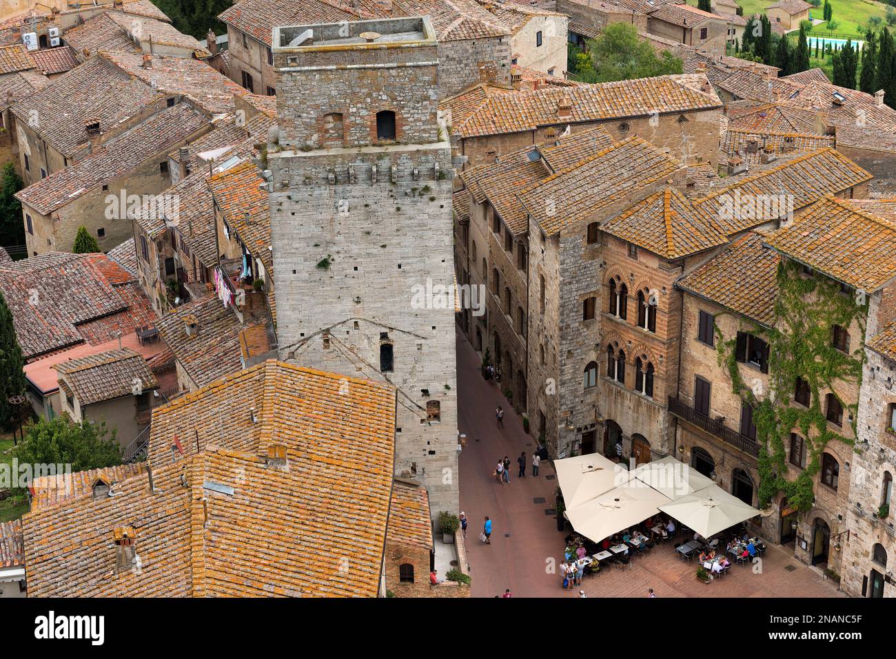 Tourists visit the ancient and medieval Cisterna square (piazza della ...