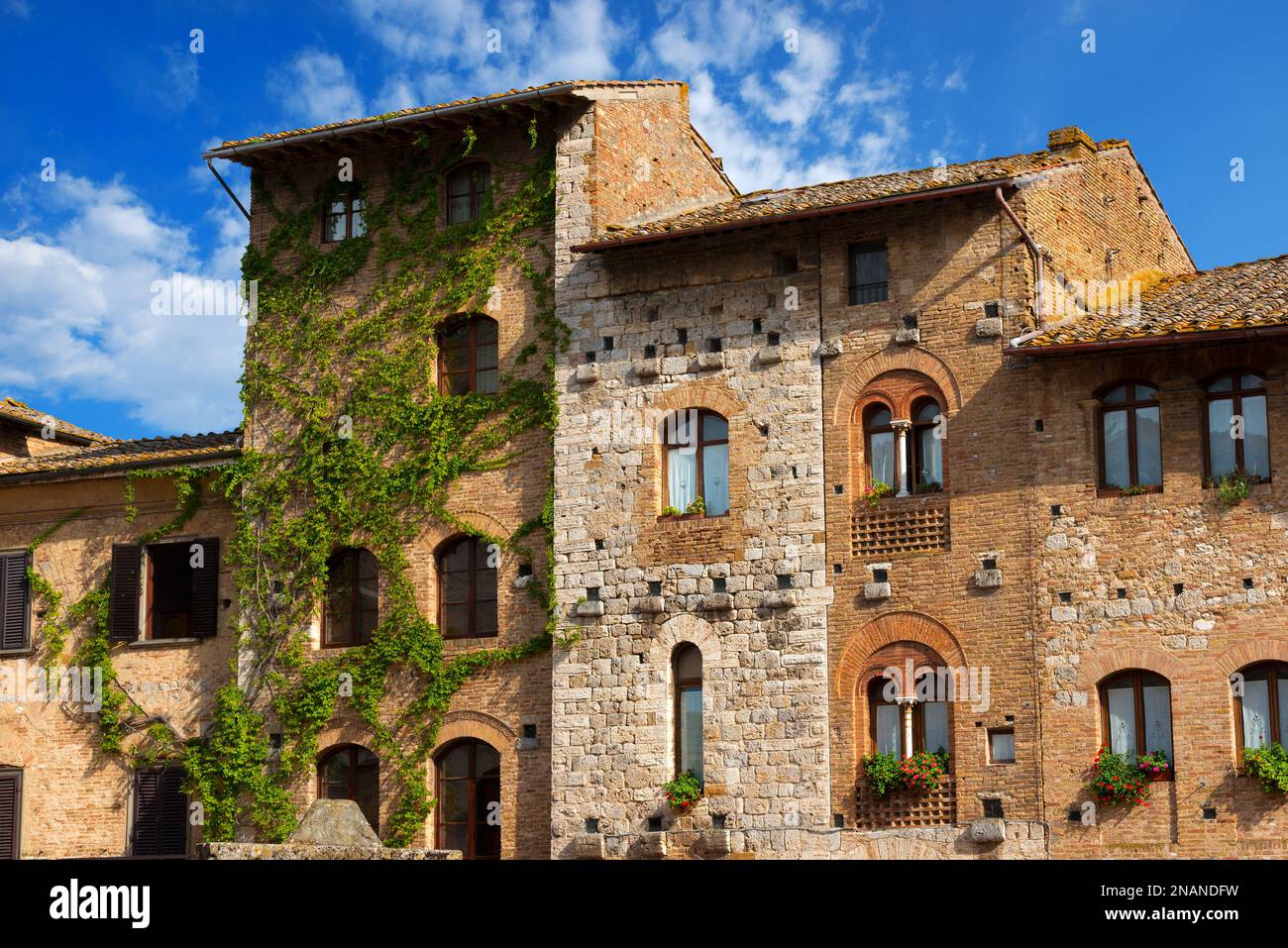 Ancient houses in San Gimignano downtown, Cisterna square, medieval ...