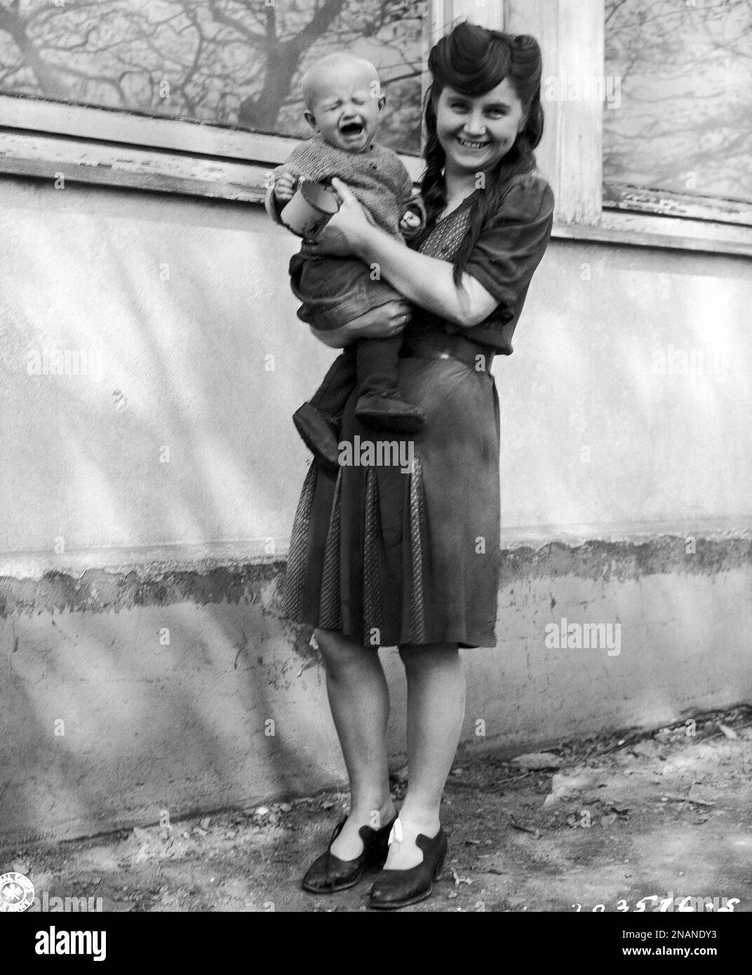 This 16-year-old unmarried German mother smiles as she holds up her ...