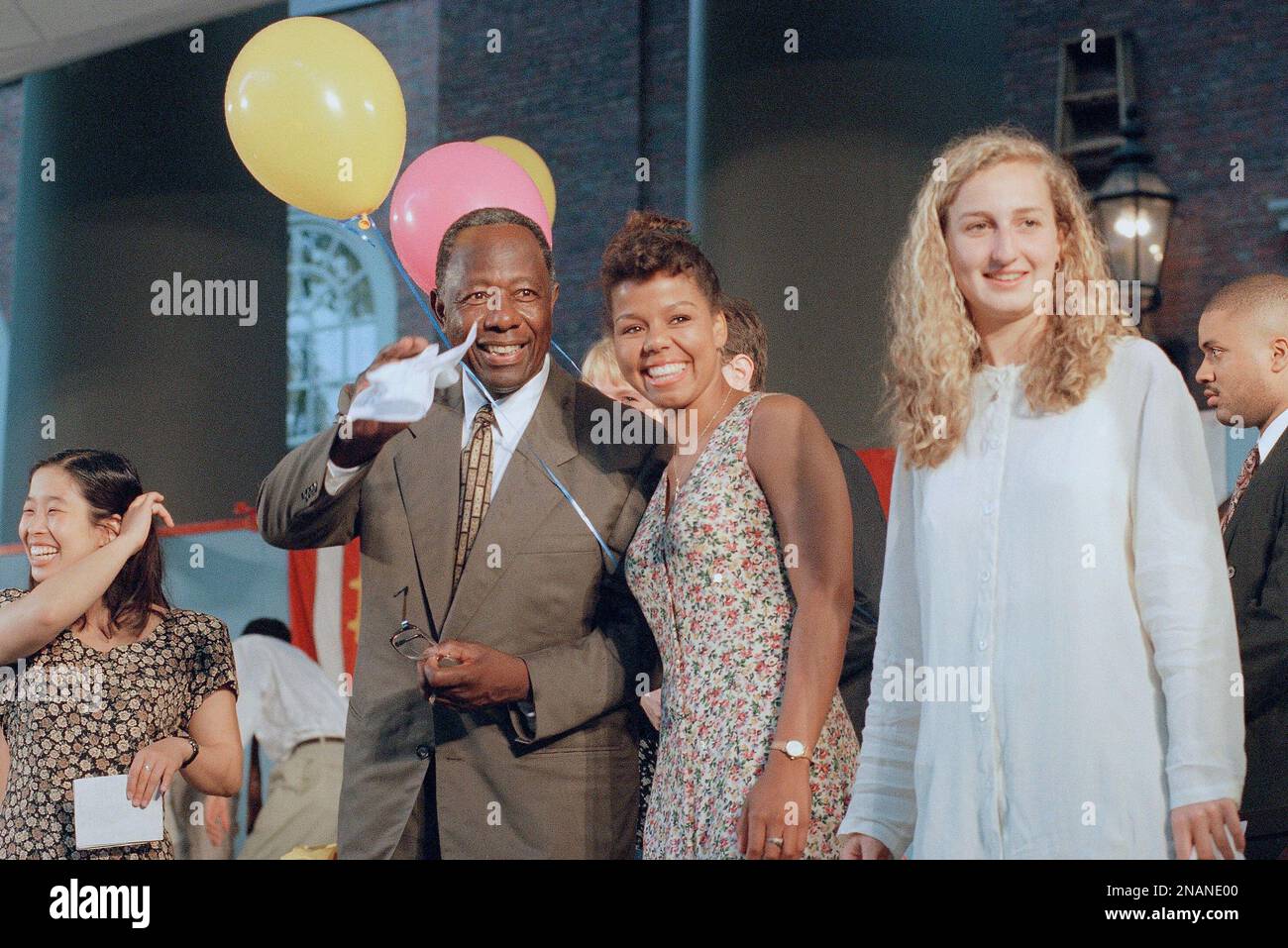 Baseball Hall of Famer Hank Aaron waves to people as he stands with ...
