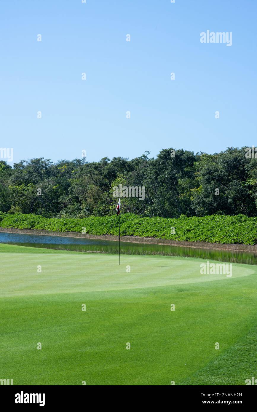 Close-up of the green with flag and water obstacles of a golf club in ...