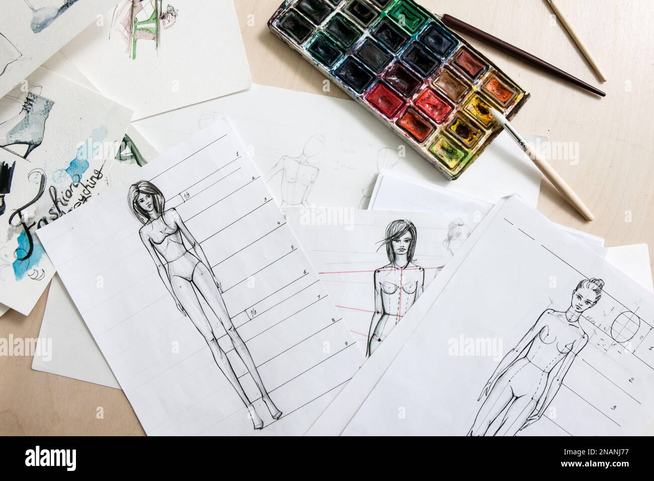 Designer fashion sketches on desk Stock Photo - Alamy