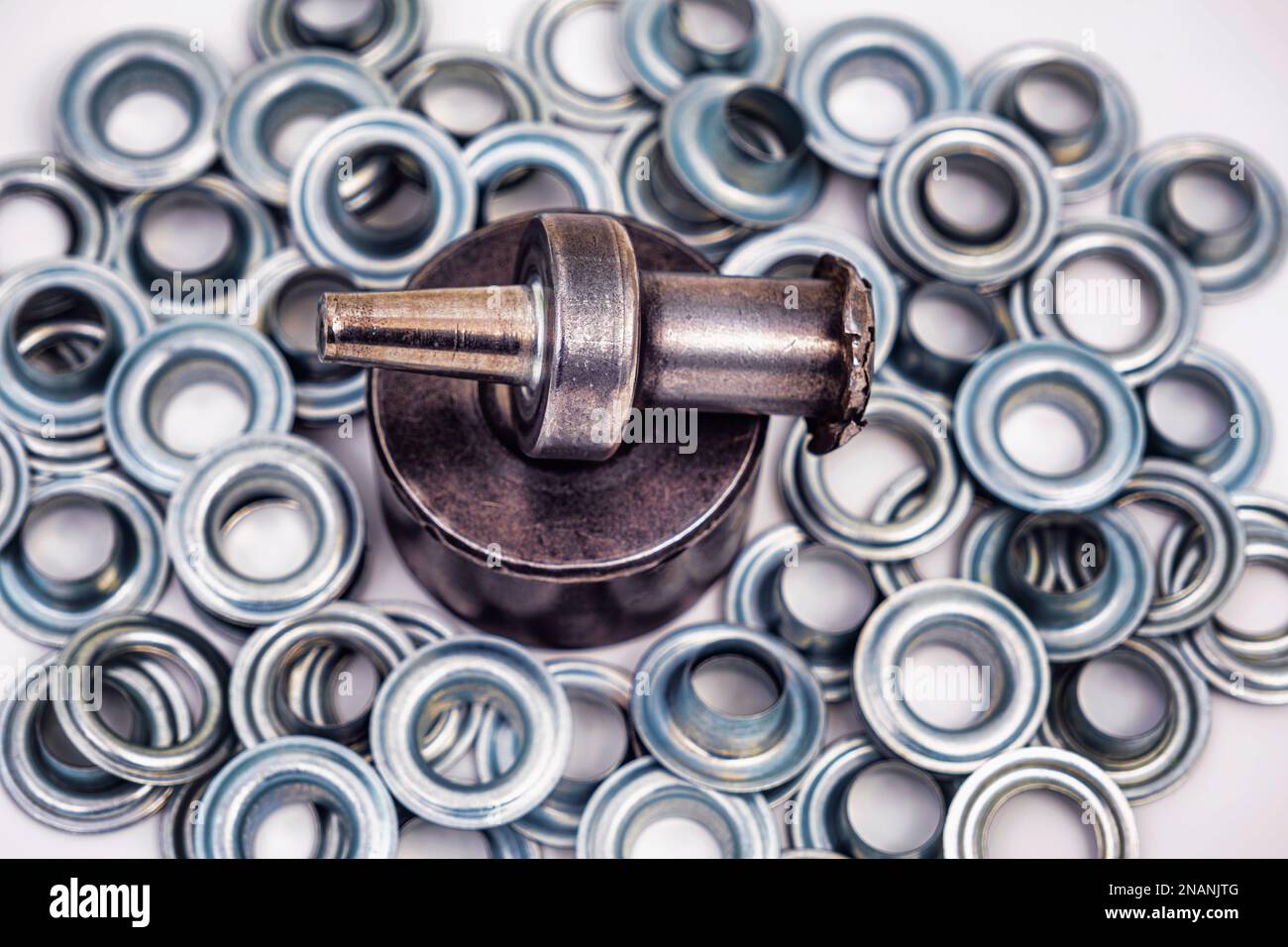 Old Used Eyelets Punching Tool and brass rings and eyelets Stock Photo ...
