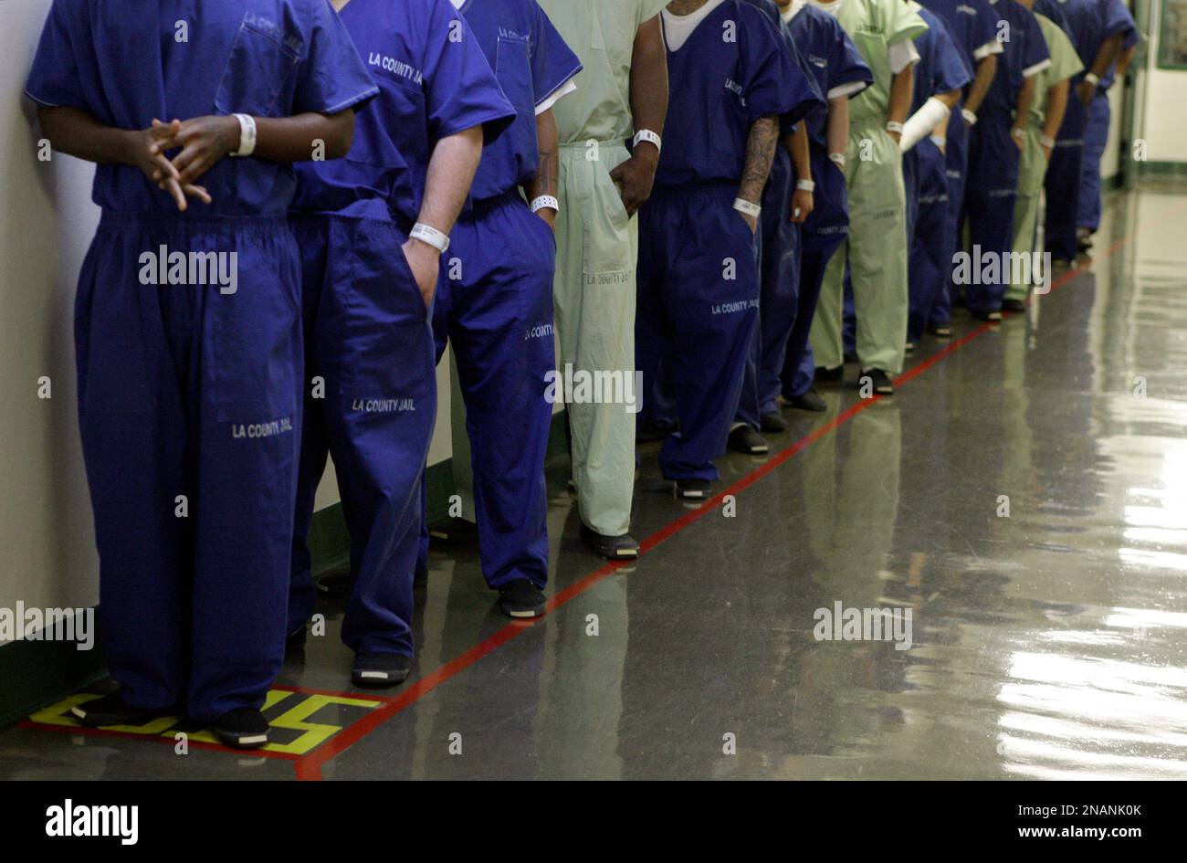 Inmates line up along a wall, seen during a tour of the Men's Central ...