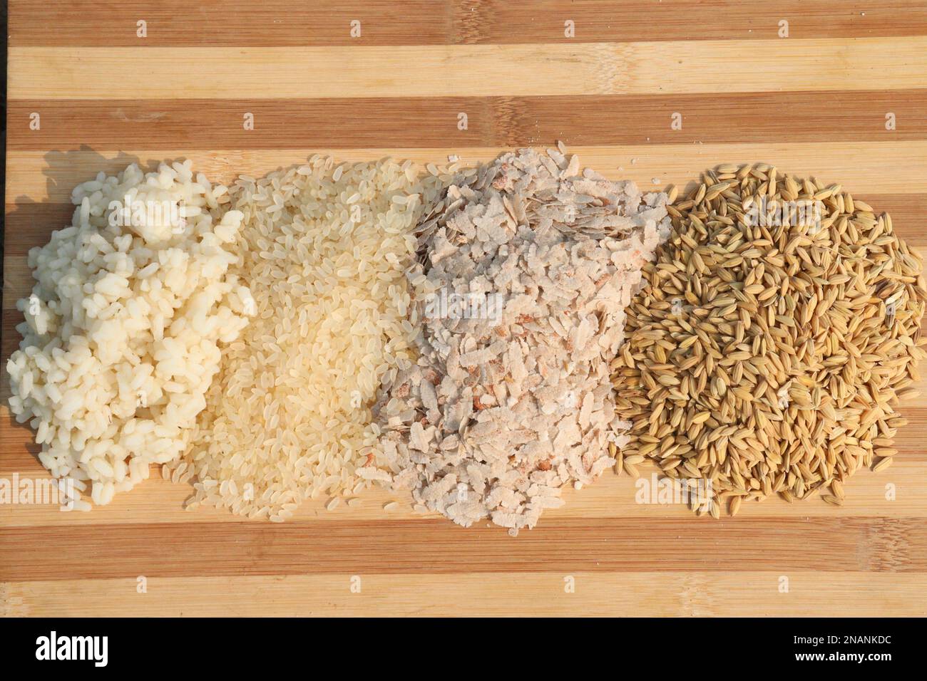 paddy and flattened Boiled dry rice on bamboo table for experiment in ...