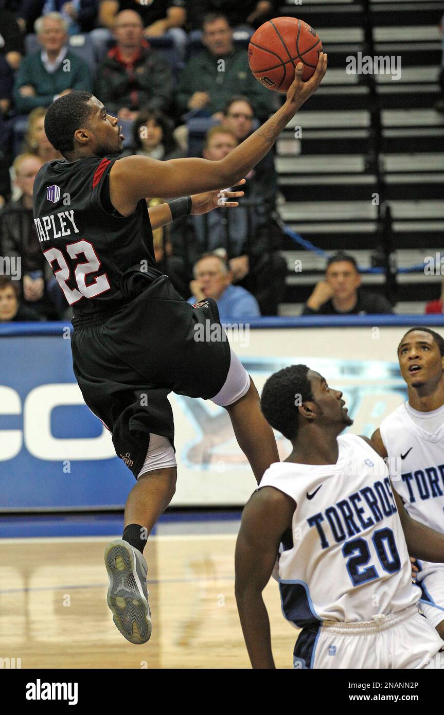 San Diego State guard Chase Tapley shoots over San Diego's Cameron ...