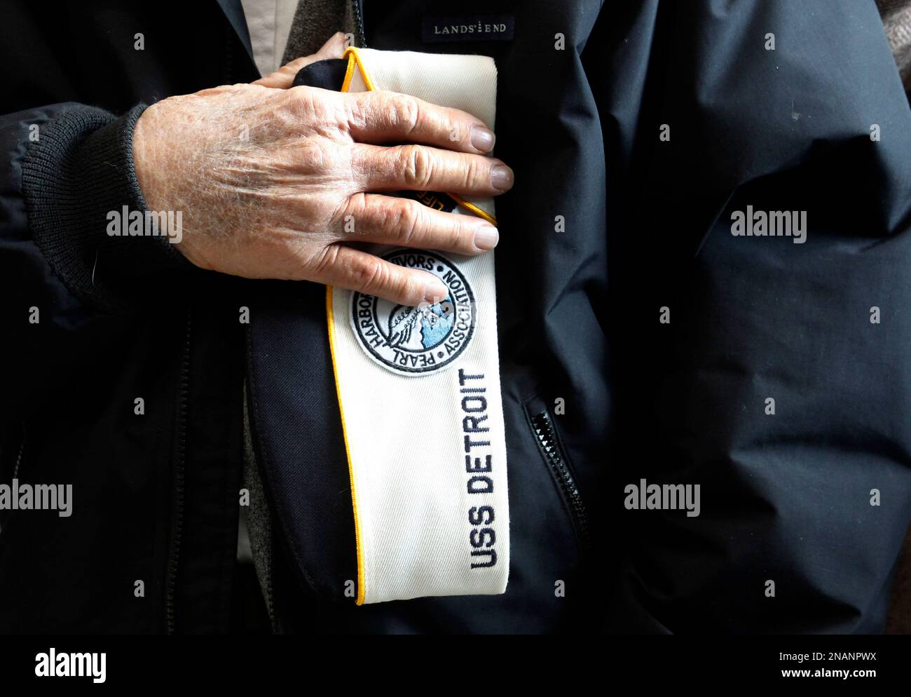 Pearl Harbor survivor John DiBetta holds his hat to his heart during a ...