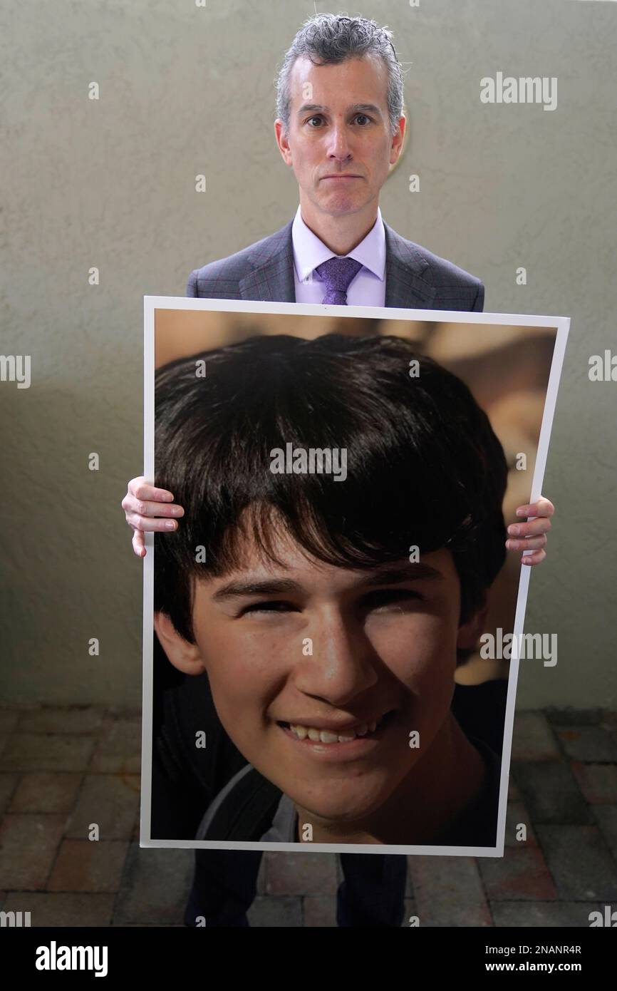 Max Schachter holds a photo of his son, Alex, during an interview ...
