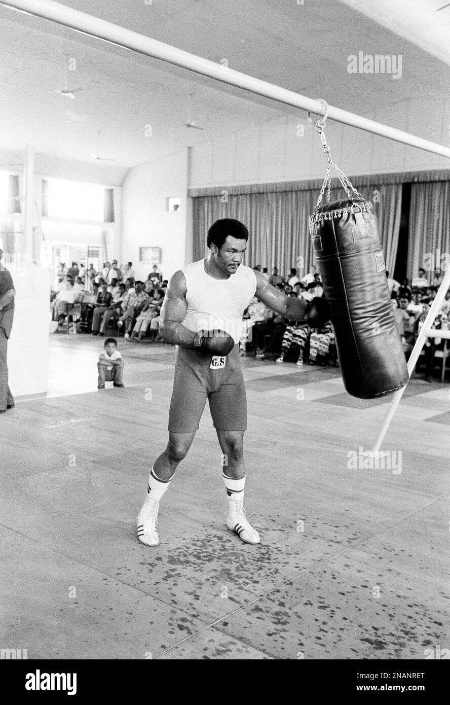 George Foreman, world heavyweight champion, hits a bag with a barrage ...