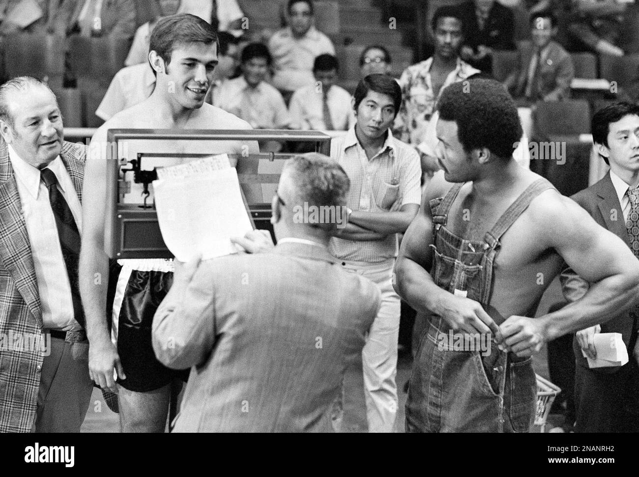Heavyweight challenger Joe “King” Roman smiles on a scale as champion ...