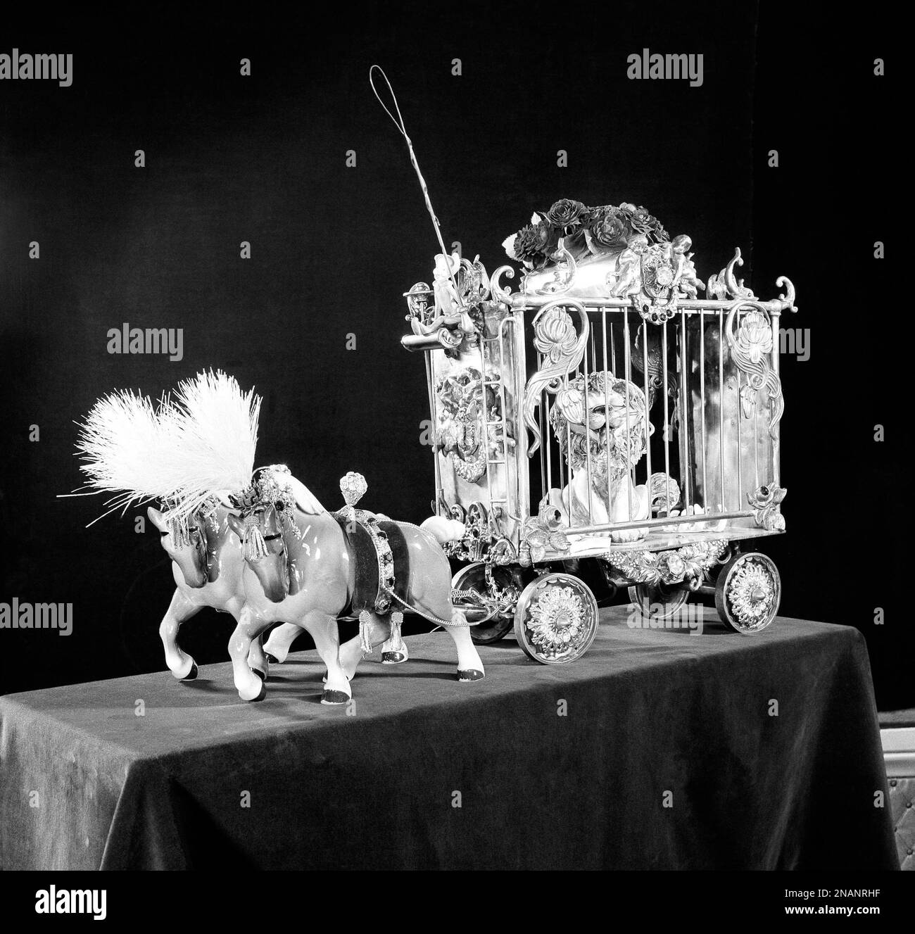 A pair of sturdy Percherons pull a cage with lion inside, one of the ...