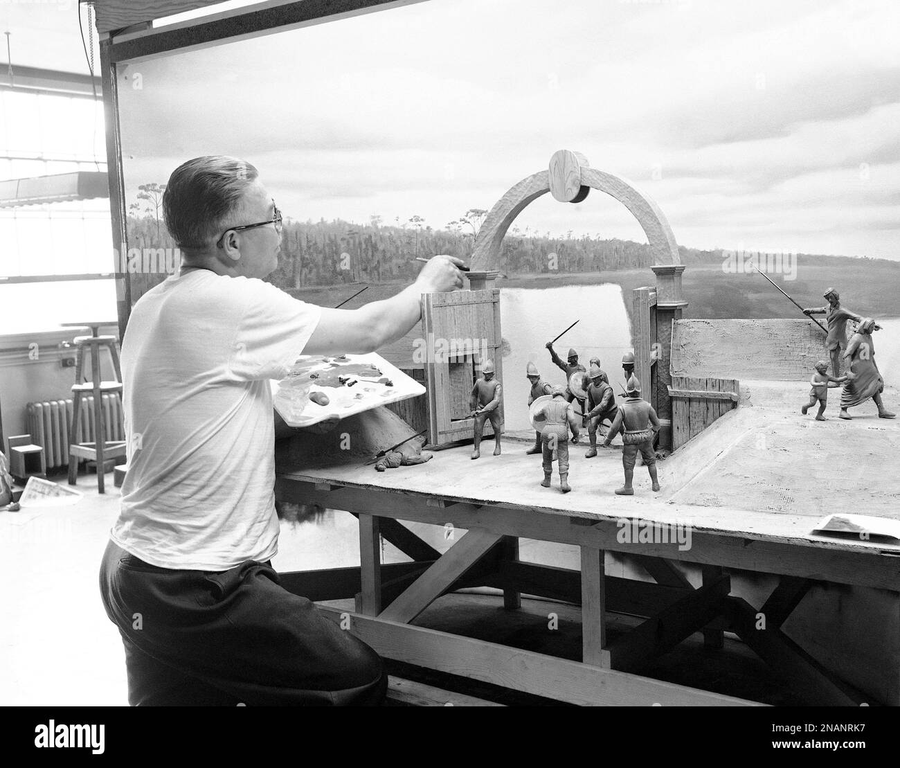 While artist Richard Jansen paints the setting, miniature Spanish ...