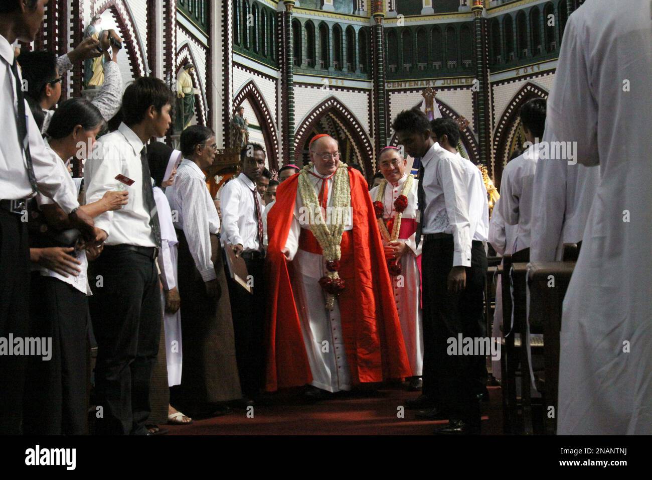 Cardinal Renato Raffaele Martino, center, a Vatican envoy, is greeted ...