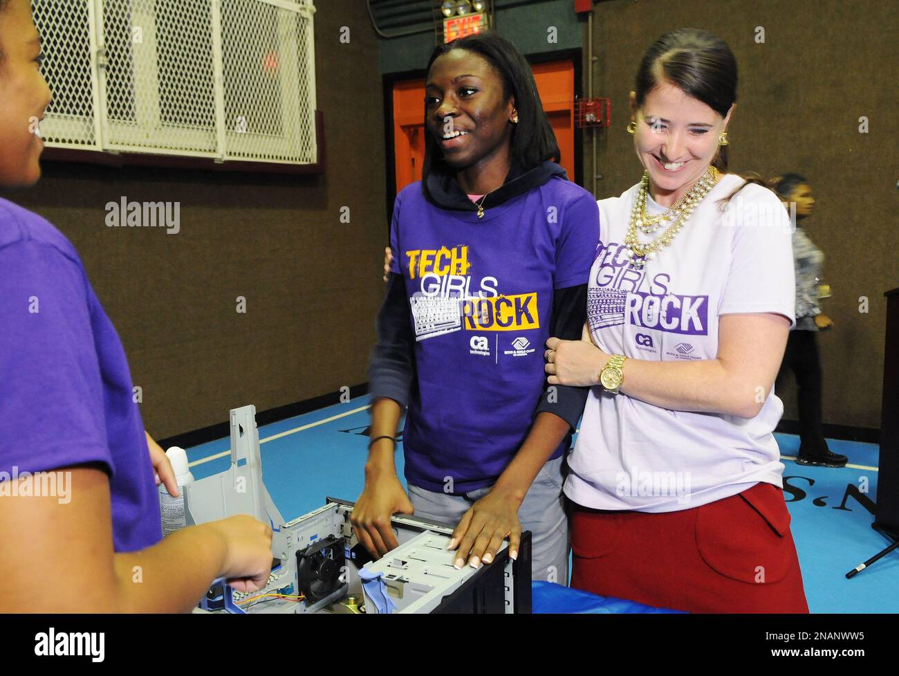 CA Technologies employee Kristie Carney, right, encourages girls as ...