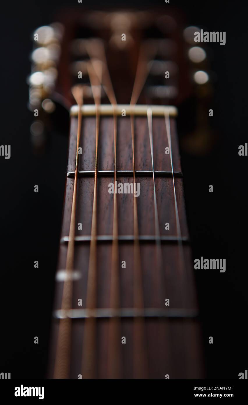 Acoustic guitar neck with strings in close up. Play classic rock music ...