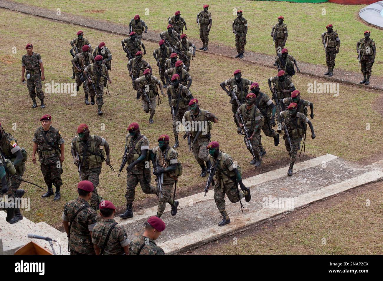 Members of a special military unit called the "kaibiles" run after a ...