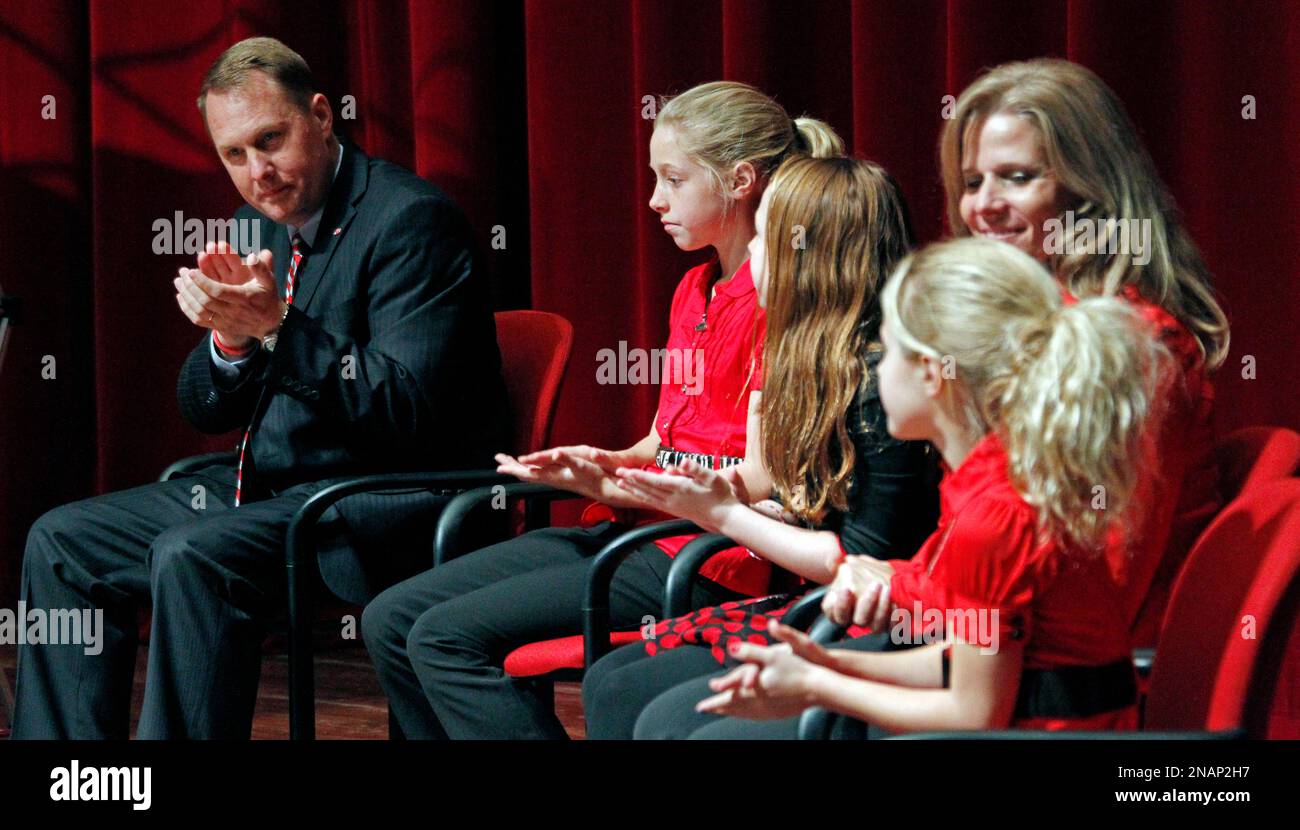 New Mississippi football coach Hugh Freeze, left, applauds his family ...