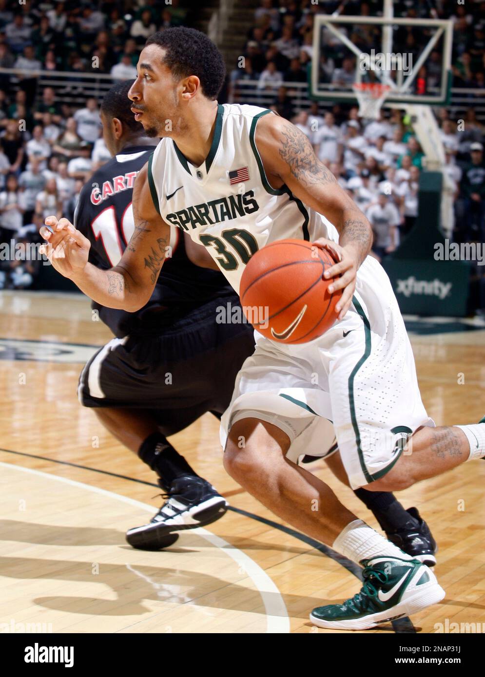 Michigan State's Brandon Wood (30) drives against Nebraska-Omaha's C.J ...